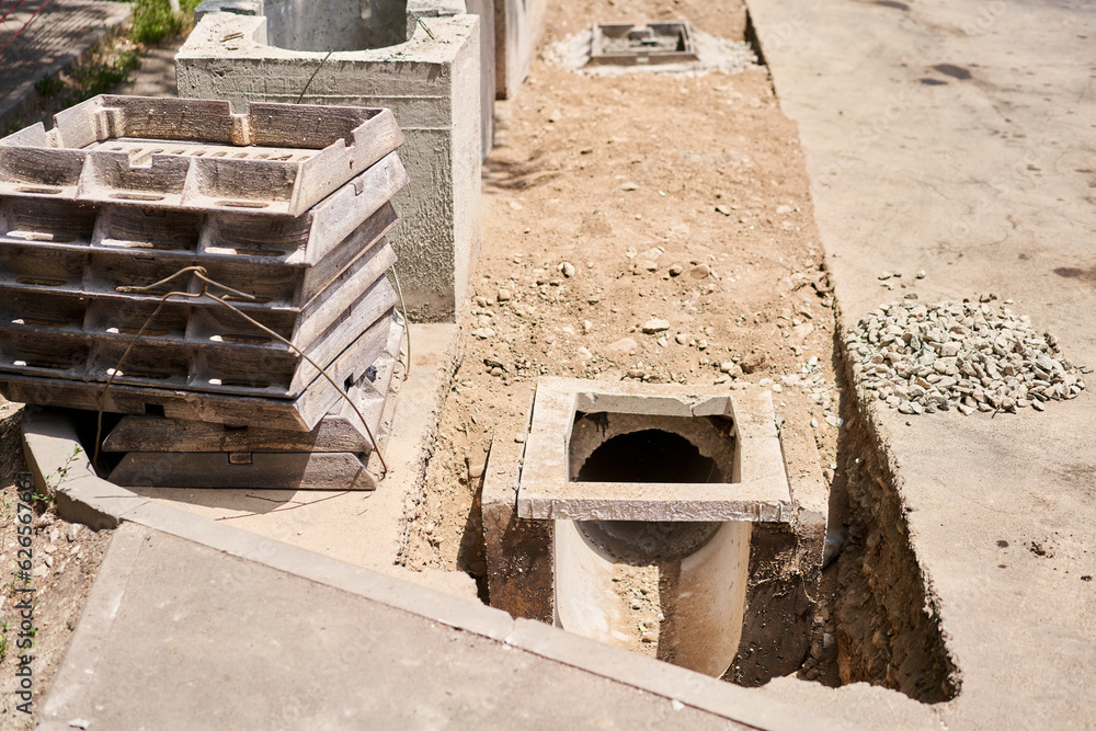Laying concrete manholes and drain pipes for stormwater system ...