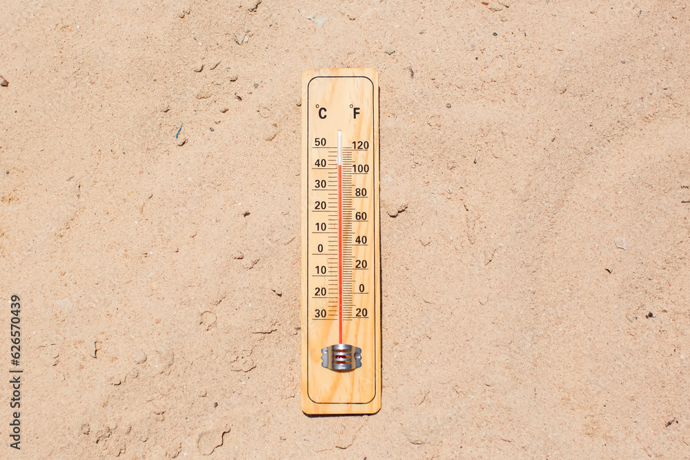 Thermometer on sand showing high temperature. Hot weather and climate ...