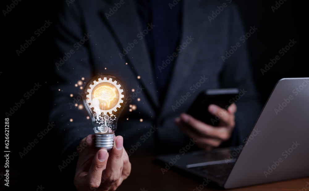 Motivation and innovation, Businessman holding light bulb with brain ...