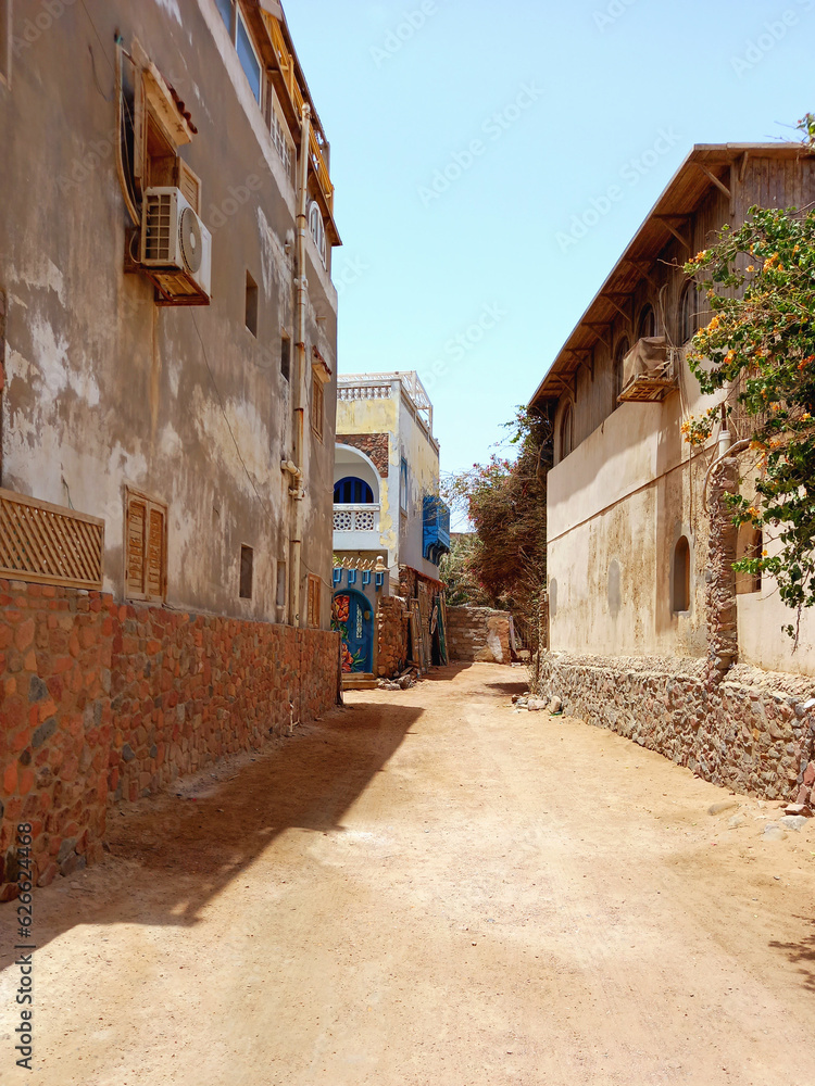 View of facades on sandy street of Dahab in the Sinai desert ...