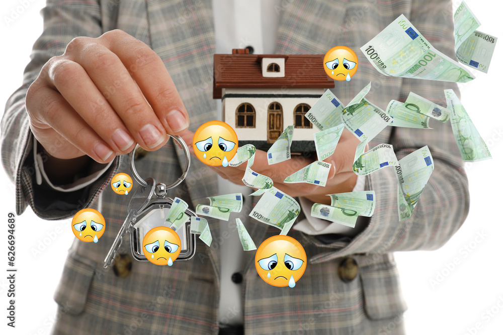 Woman with keys and house model on white background, closeup. Crying ...