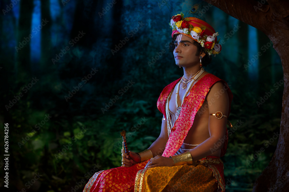 Young man dressed up as Lord Krishna on the occasion of Janmashtami ...