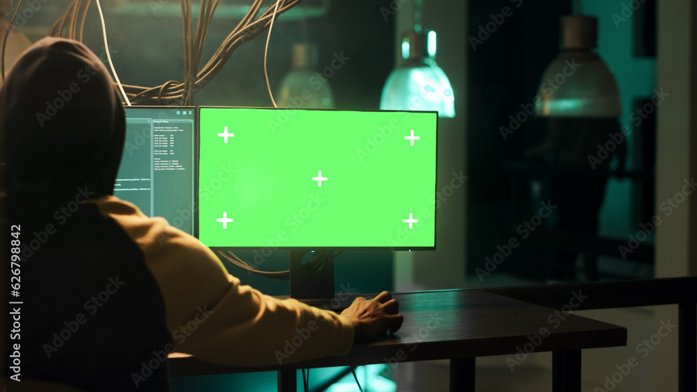 Male spy using computer display with greenscreen while stealing ...