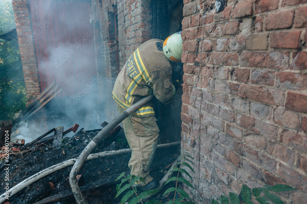 Ukrainian rescuers put out a fire in the house. Firefighters put out ...