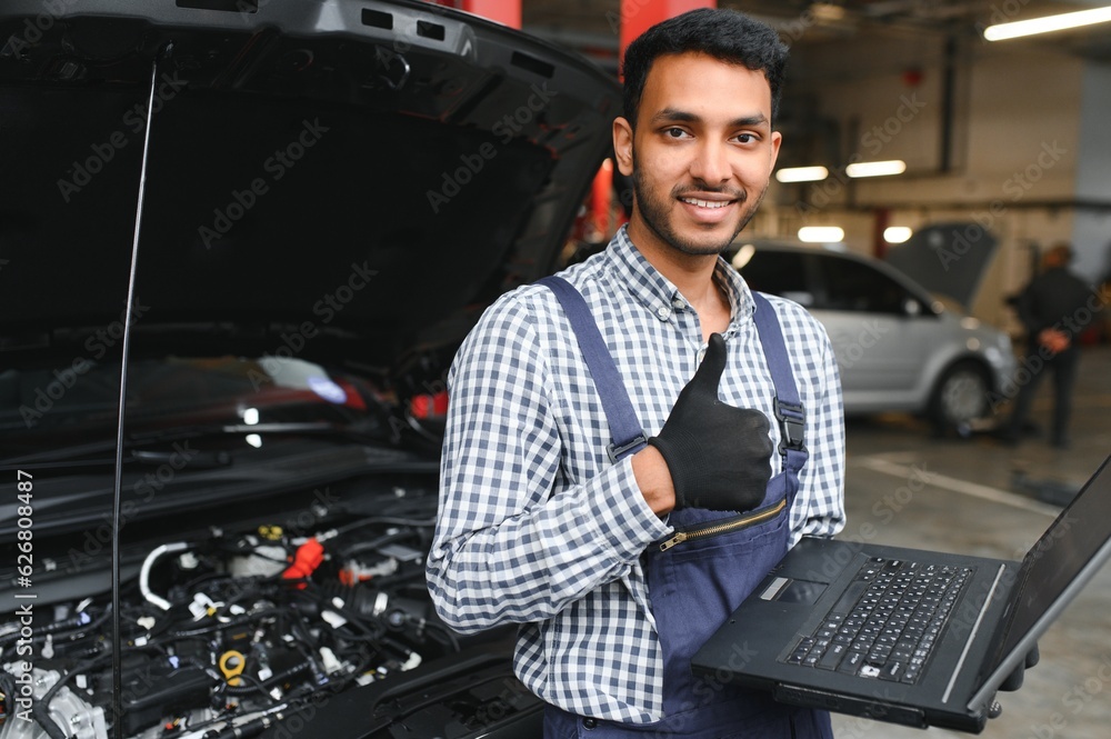 Indian car mechanic standing and working in service station. Car ...