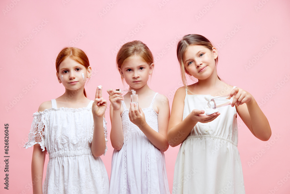 Pretty little girls, children using natural cosmetological face ...