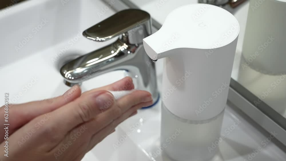 Washing hands with liquid foam soap. Hands collect small amount of foam ...