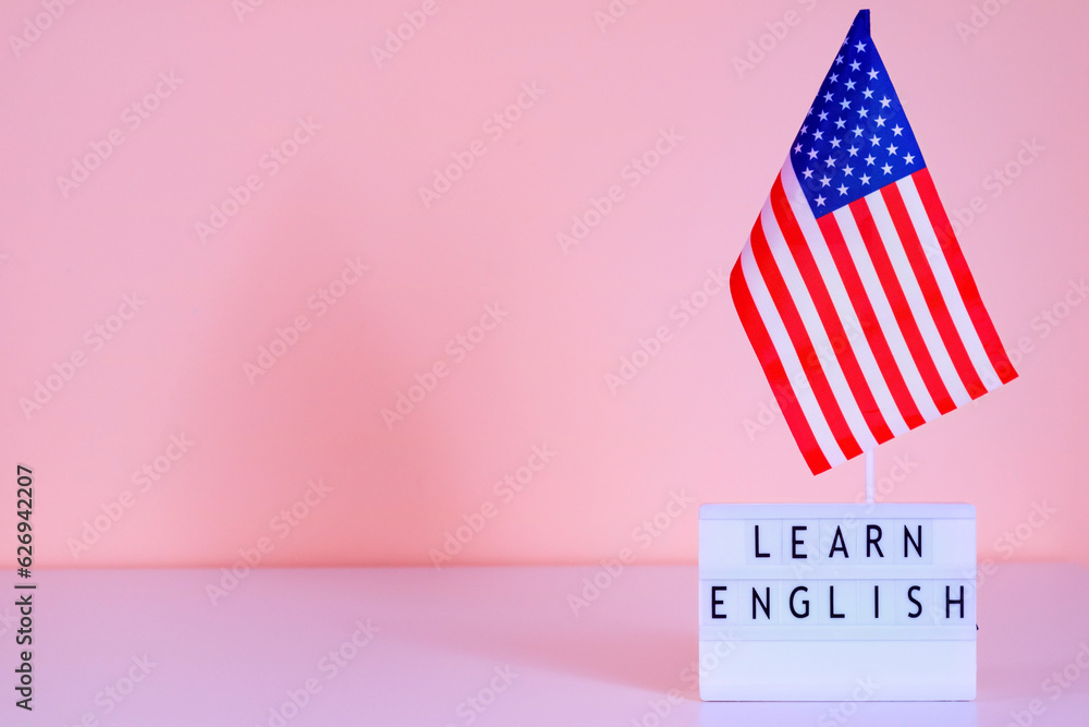 Banner - USA flag and text learn English on a pink wall background ...
