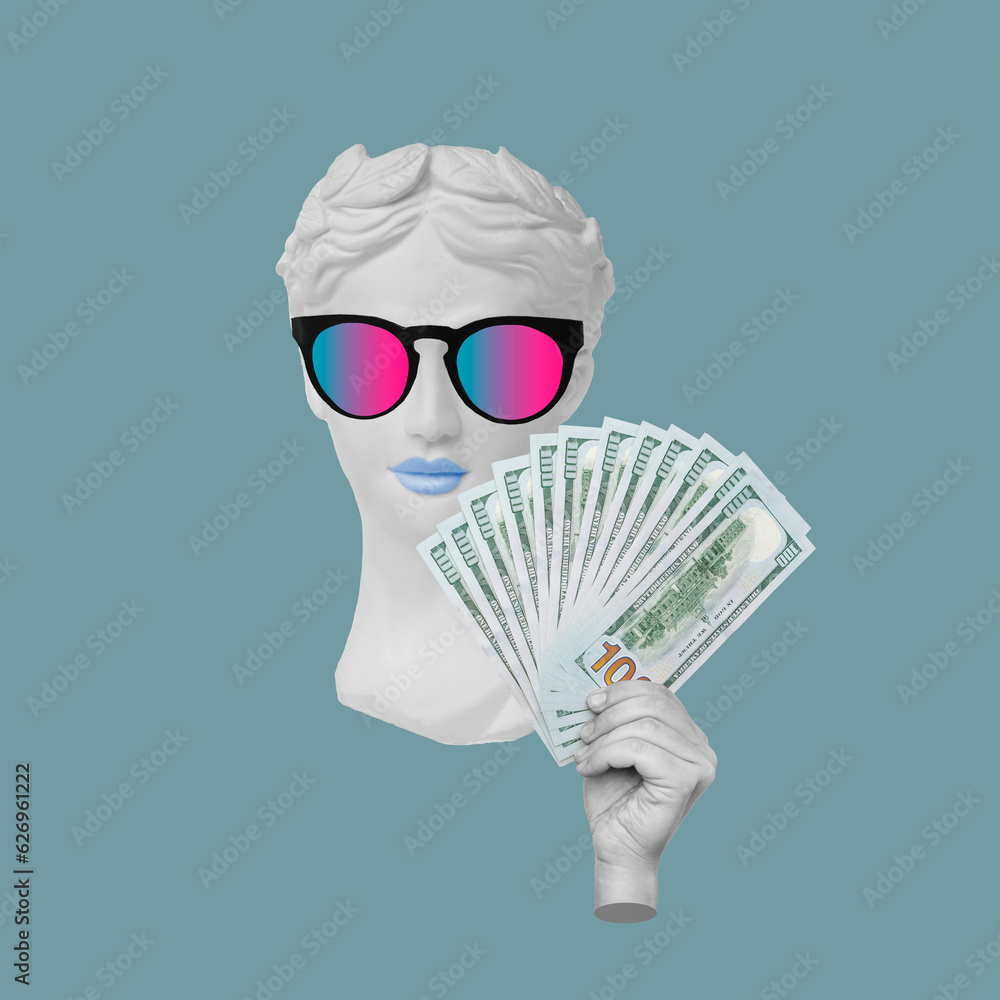 Antique female smiling statue's head in colorful sunglasses holds a wad ...