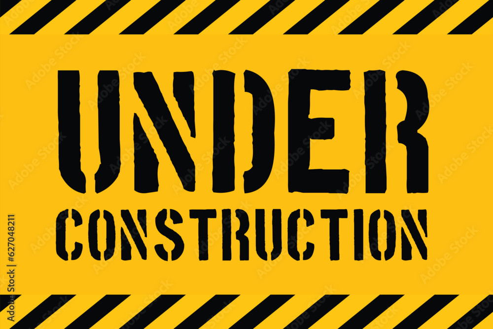 Under construction warning sign text with yellow black stripes painted ...