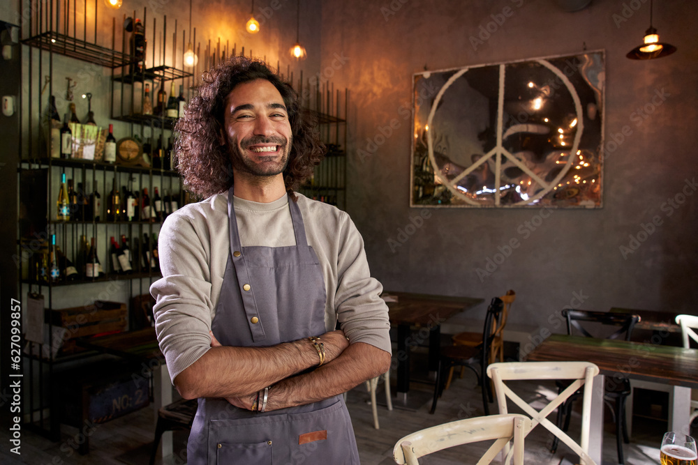 Portrait of a young caucasian man looking at camera in a restaurant ...