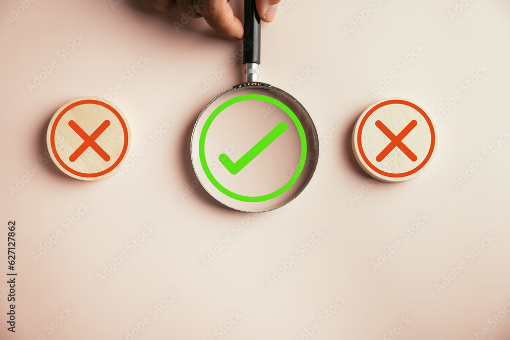 Focusing on the right choice concept, a hand holds a magnifying glass ...