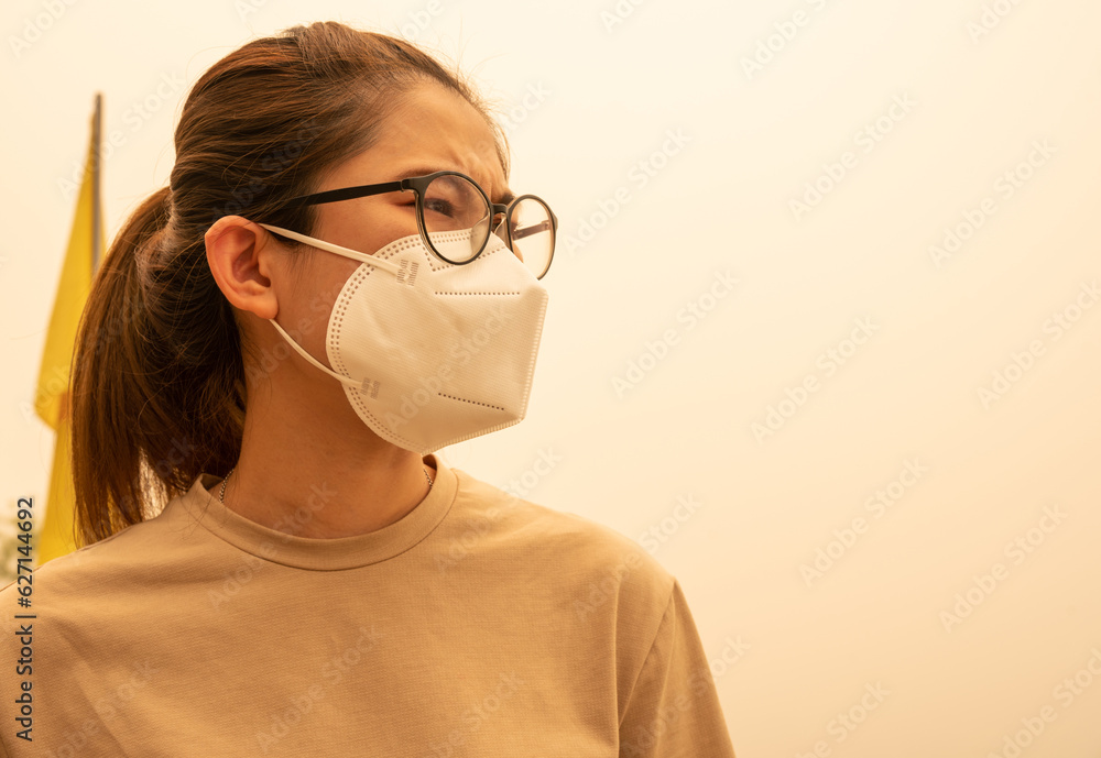 Worried Asian woman wearing an N95 mask for protect bad air pollution ...