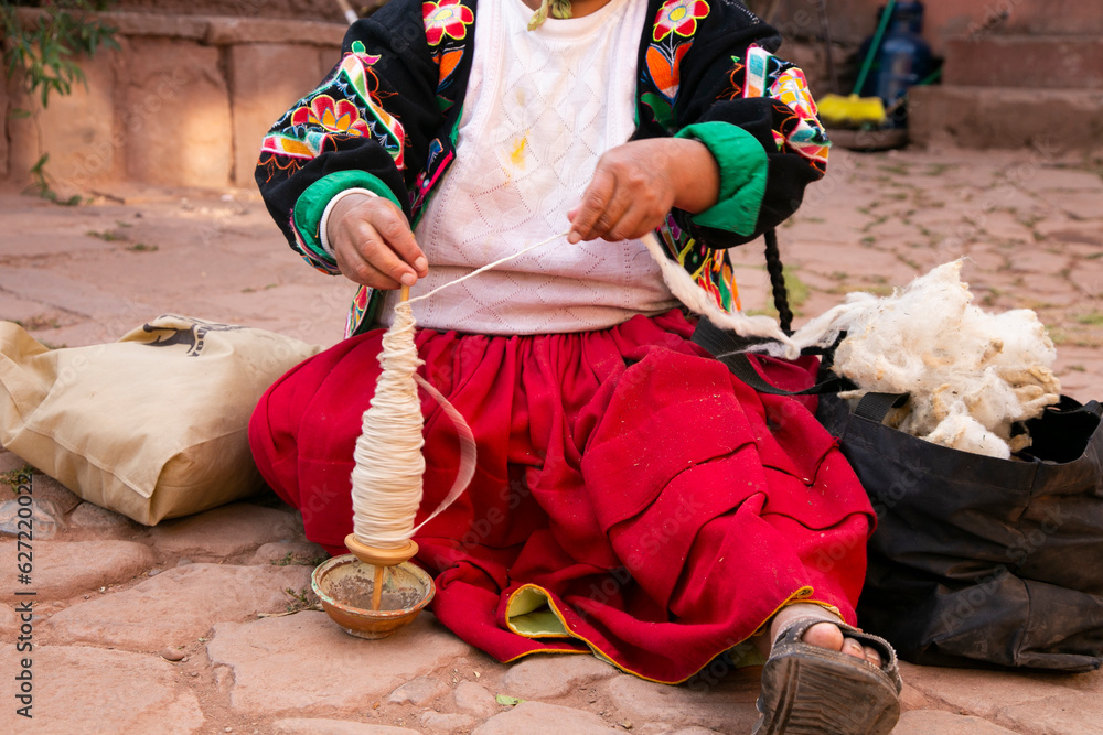 Indigenous woman working on the elaboration of textile handicrafts in a ...