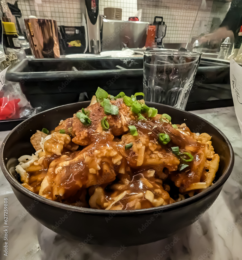 vegan general tao poutine on a bar in a restaurant Stock Photo | Adobe ...