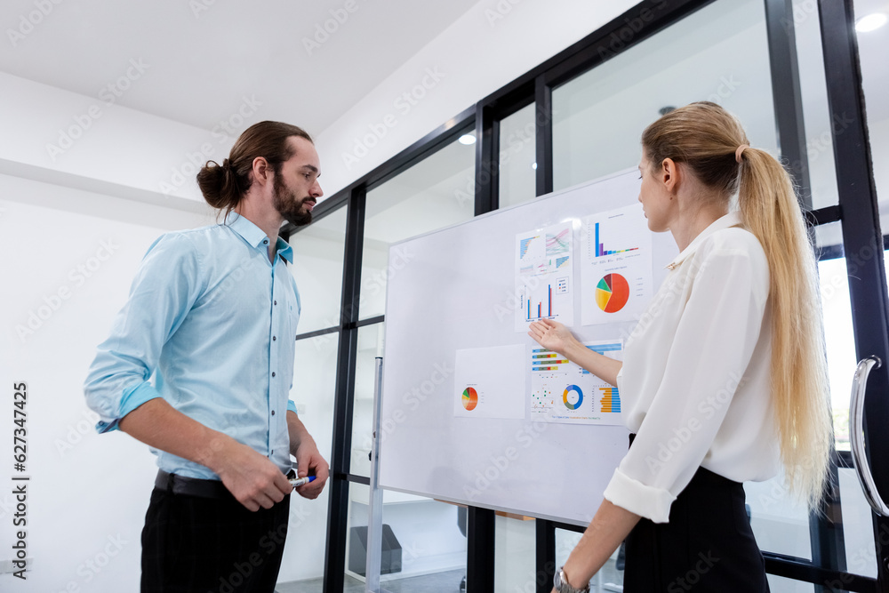 Female manager pointing finger graph and looking at presentations on ...