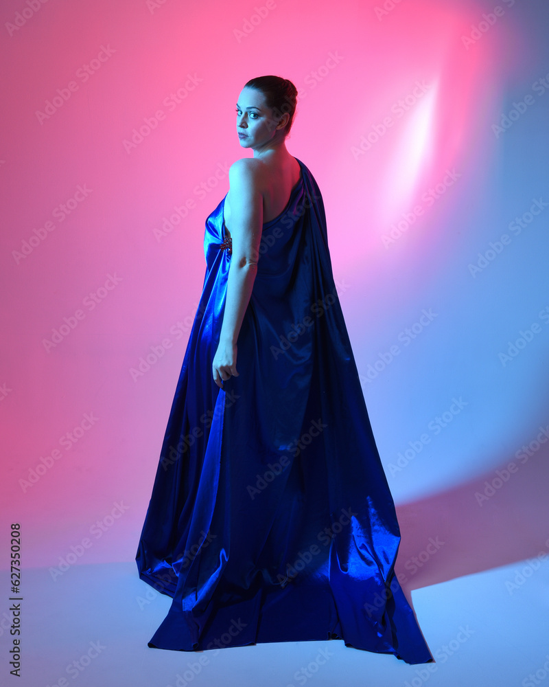 Full length portrait of beautiful female model wearing elegant flowing ...