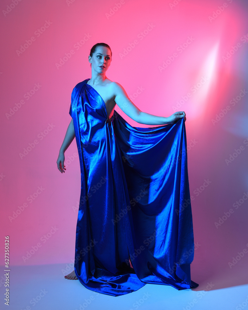 Full length portrait of beautiful female model wearing elegant flowing ...