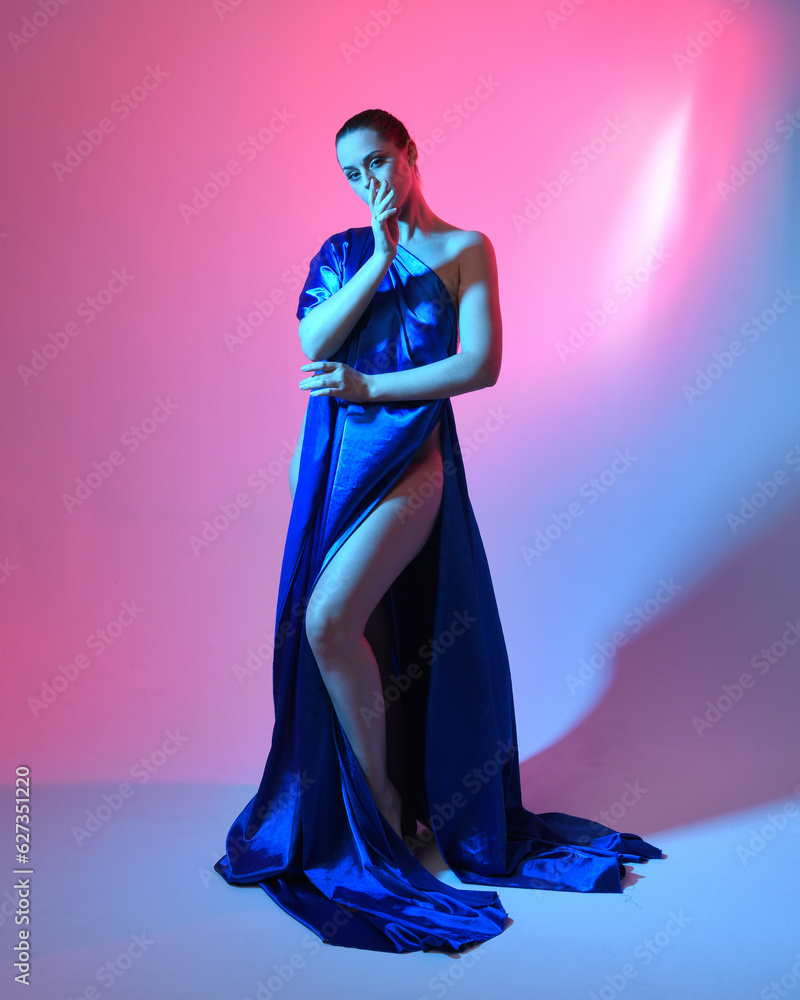 Full length portrait of beautiful female model wearing elegant flowing ...