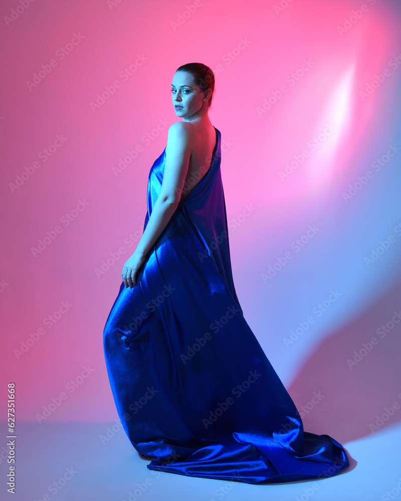 Full length portrait of beautiful female model wearing elegant flowing ...