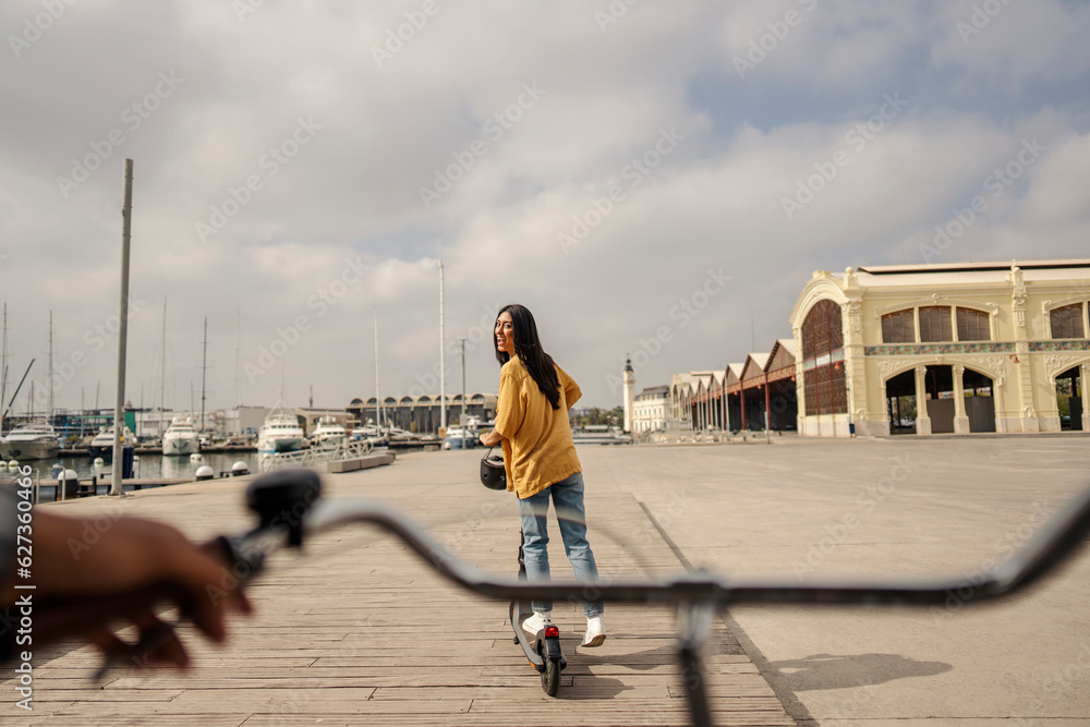 The eco tourists are using eco-friendly rides for sightseeing. In a blurry foreground are hands ...