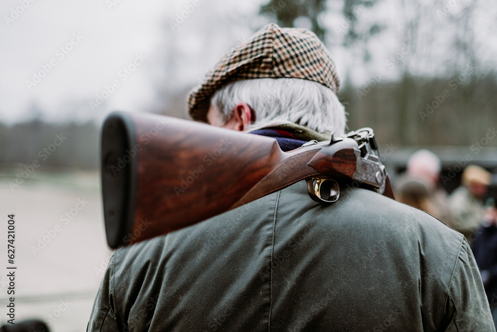 Older man on a hunt. Senior hunter with grey hair, tweed cap and ...