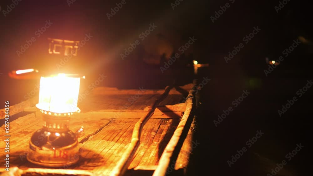 Bamboo raft with a burning lantern floats through natural limestone ...