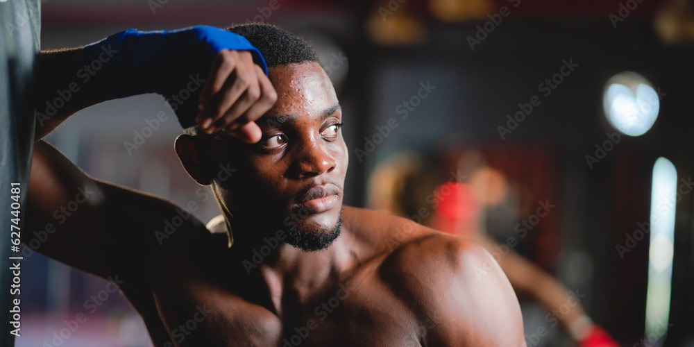 Young muscular african american male boxer looking at camera, wearing ...