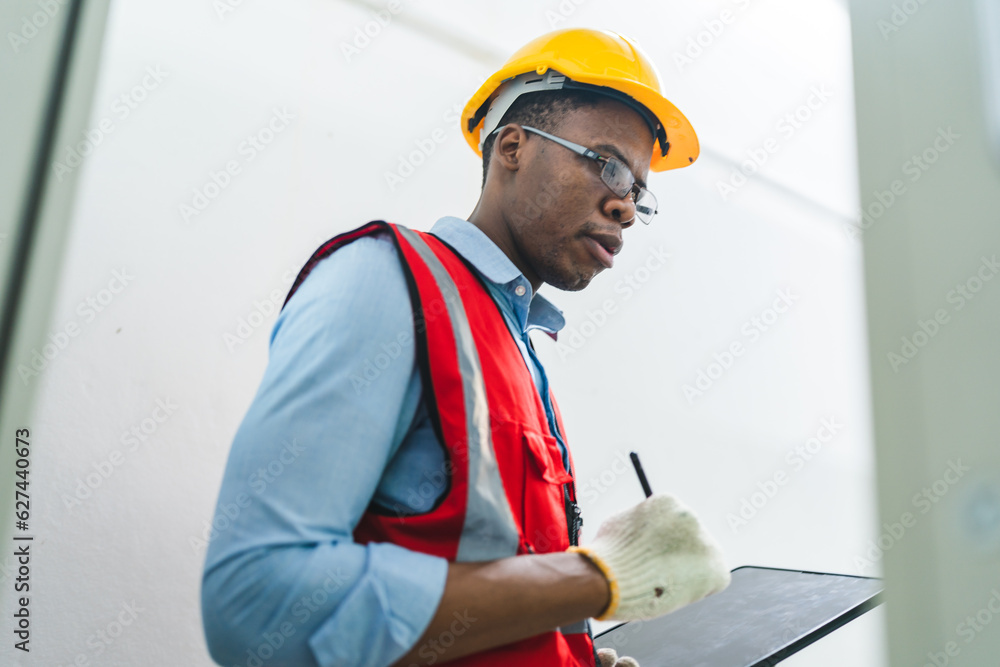 Professional engineering of modern factory checking to automatic machinery. Black worker with ...