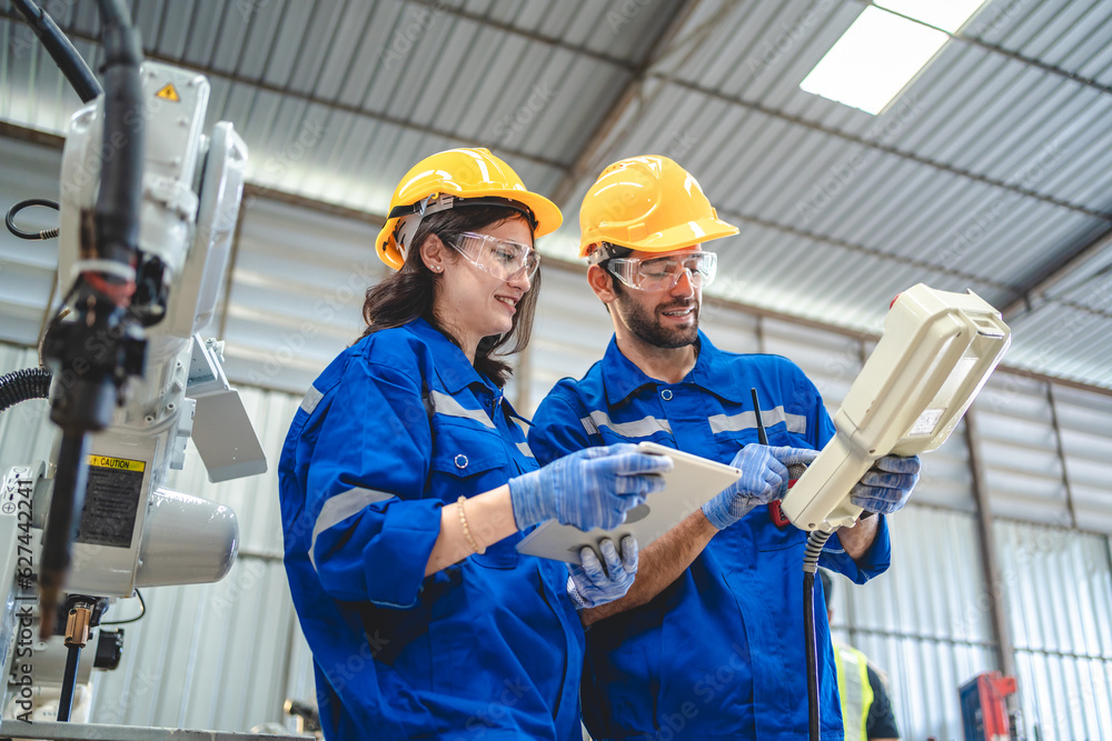 Engineer people service robot working in automation factory. Worker ...