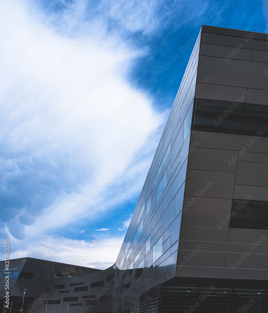 Large dark office building with odd angles. Stock Photo | Adobe Stock