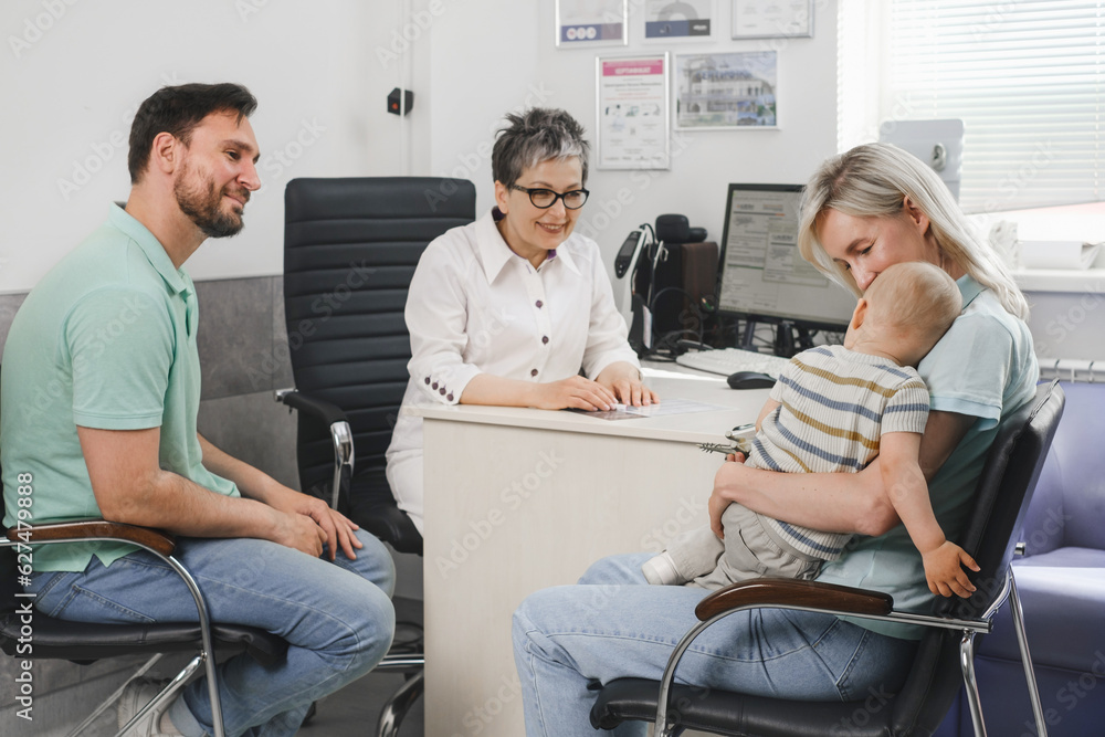 Family at kids hearing check-up. Parents with infant child consulting ...