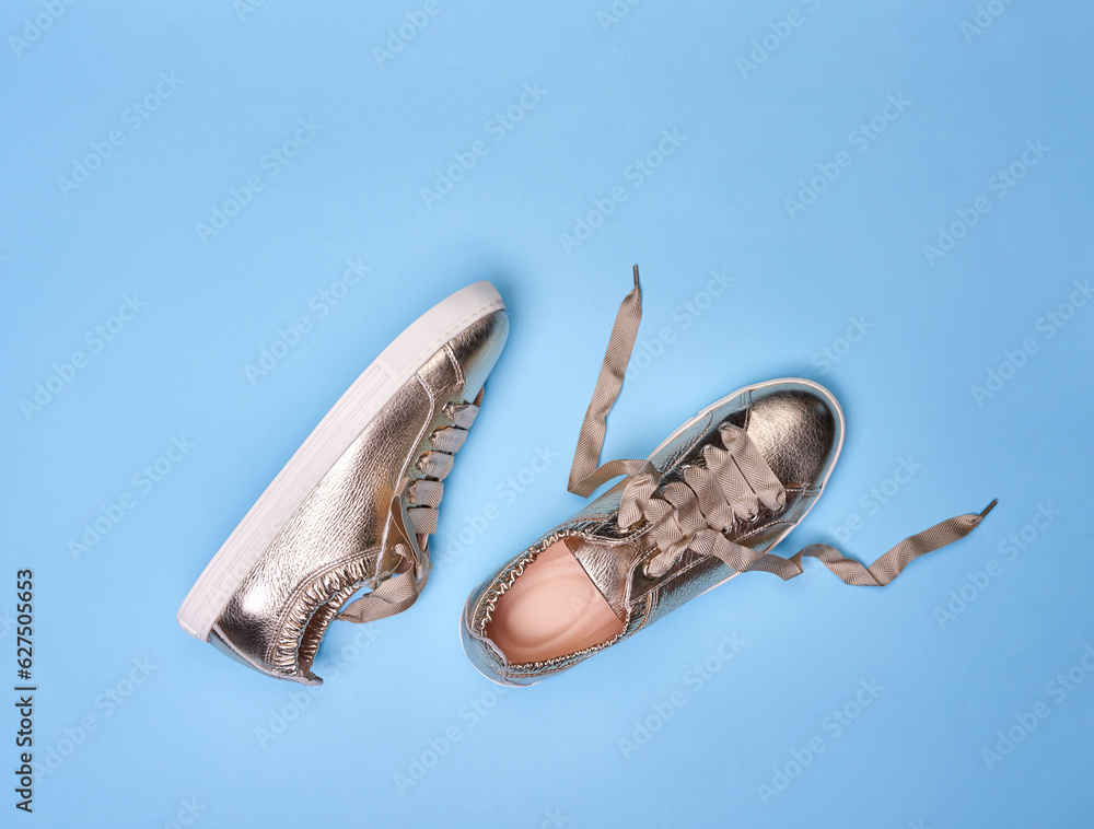 Stylish golden metallic sneakers with wrinkled leather details and ...