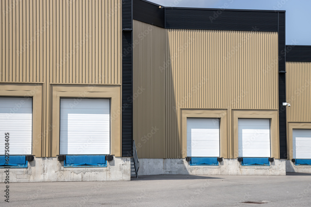 Facade of a high bay commercial building showing empty loading docks ...