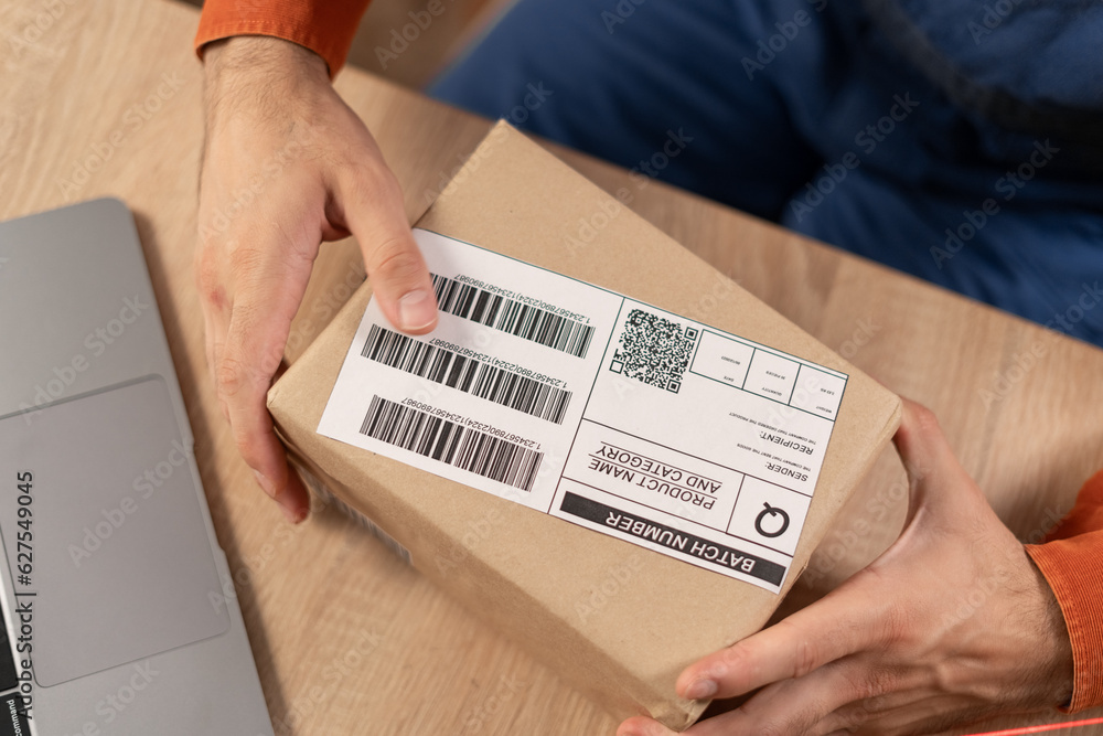 Male entrepreneurs packing product shipping order box for dispatching ...