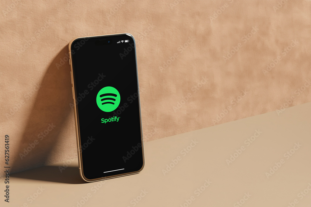 Spotify music app on the smartphone iPhone screen. Leaning against the ...