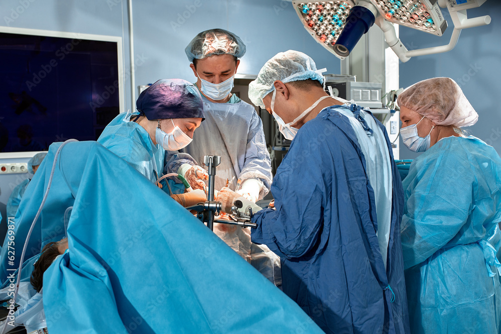 Surgeons team during complex surgical operation in a sterile operating ...