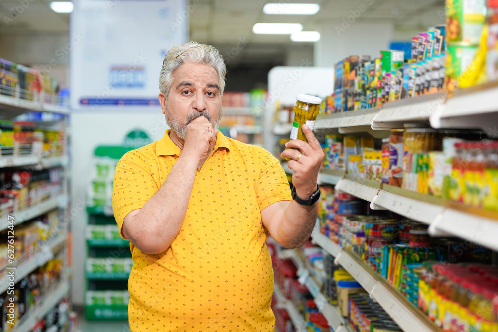 Senior indian man shocking expression on inflation at grocery shop. Stock Photo | Adobe Stock