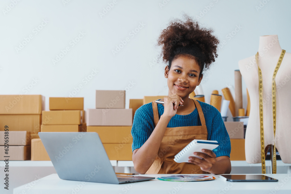 Pretty African American sme business woman working Custom Ecommerce ...