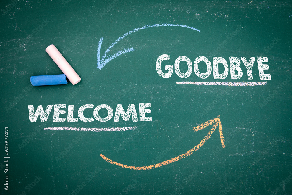 WELCOME and GOODBYE concept. Colored pieces of chalk on a green ...