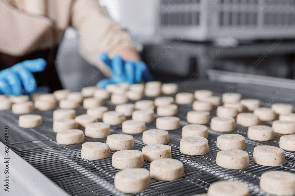 Sweets candy move on industry conveyor, background worker. Chocolate ...