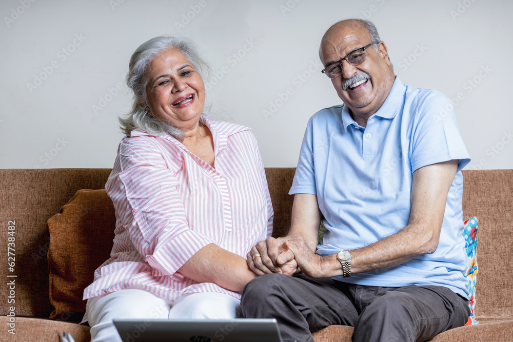 Indian couple sitting on sofa with head joint together having Quality ...