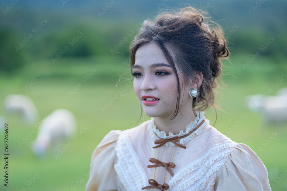 A pretty young Asian teenage girl wearing Victorian or Edwardian-era ...