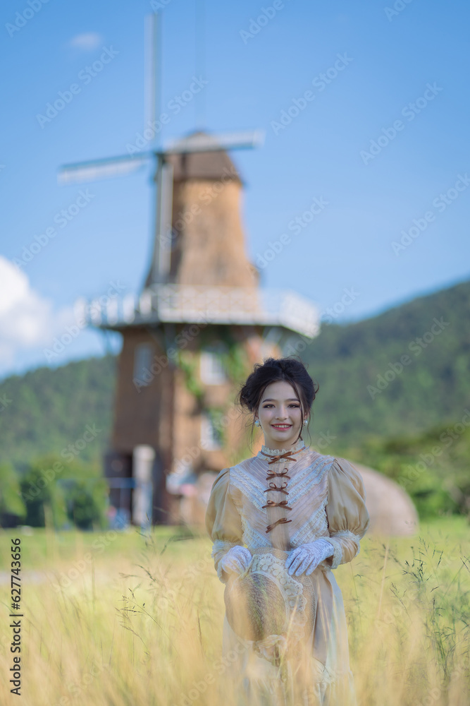Teenage girls in old-fashioned costumes are standing happily in the ...