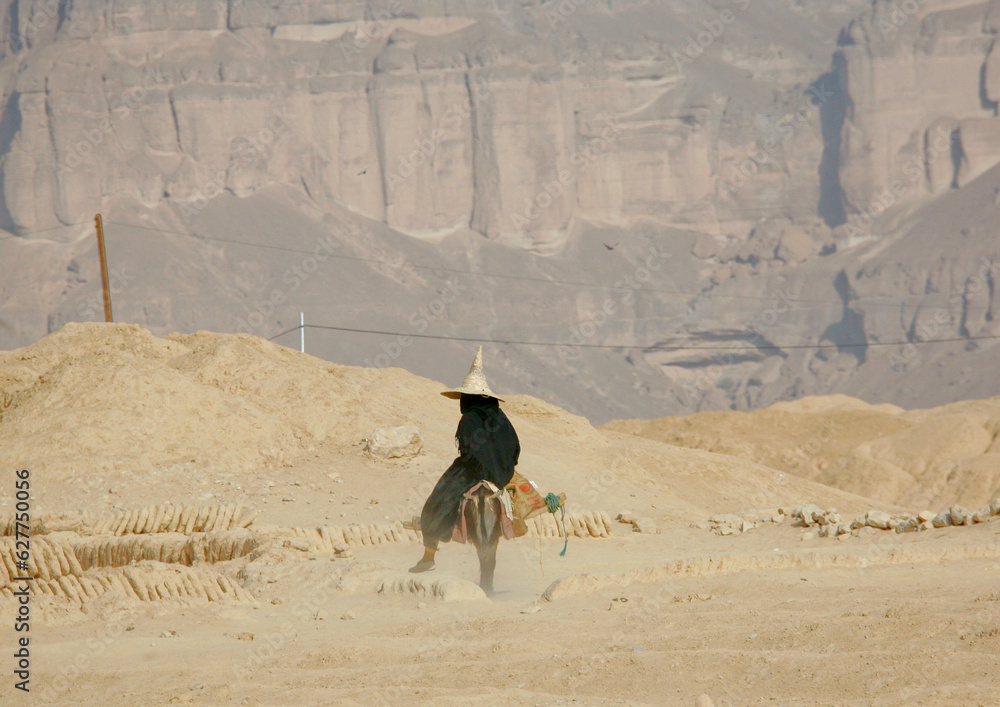 Hadramout woman with a full black dress, gloves and a high hat; The ...