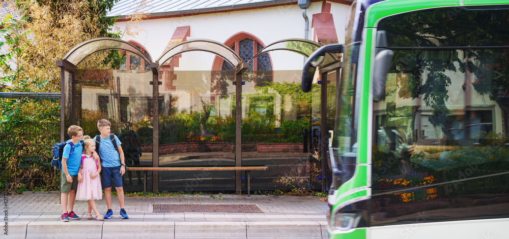 Group of little kids students talking while waiting for school bus at ...