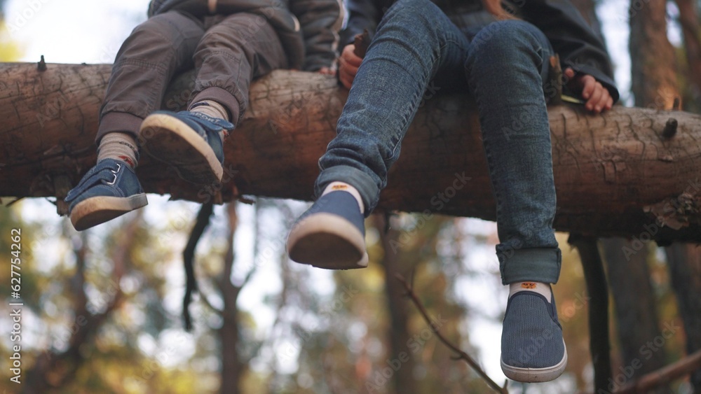 children sitting on a tree in the park. happy family childhood dream ...
