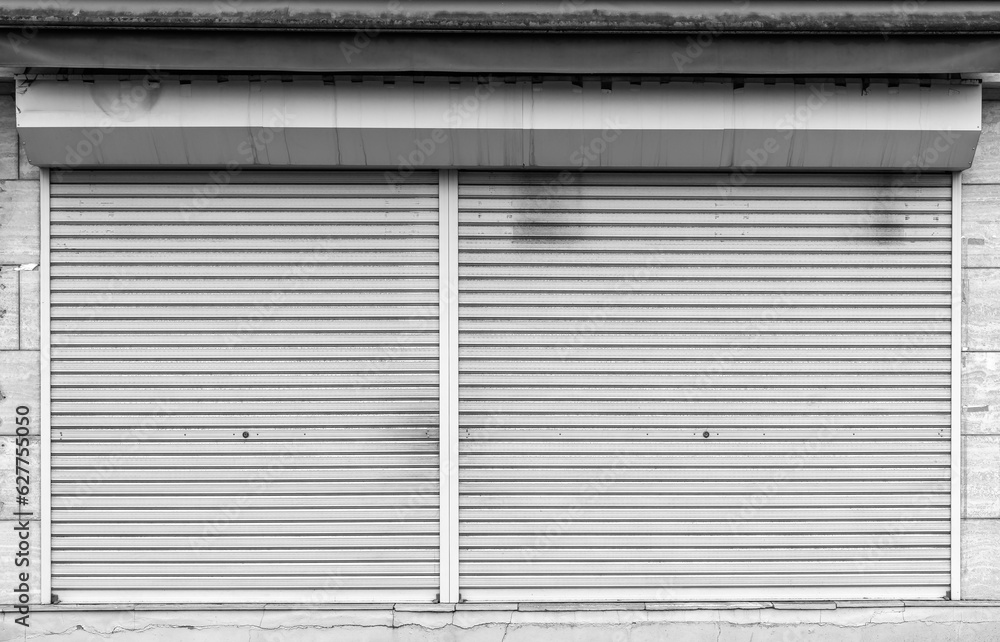 Closed steel shutter door of warehouse, storage or storefront for metal ...
