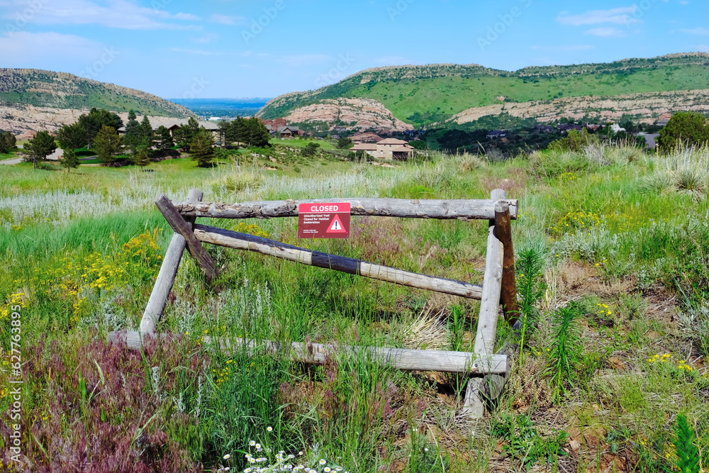 Buck fence with Closed Trail sign along hiking trail in mountains ...