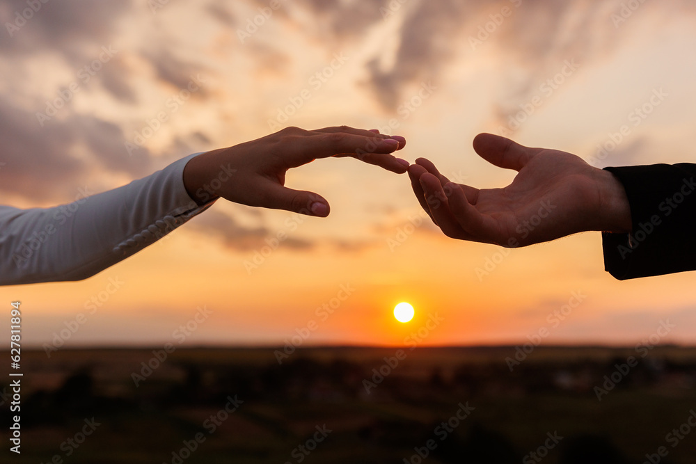 Hands of bride and groom reaching each other, touching fingers on ...